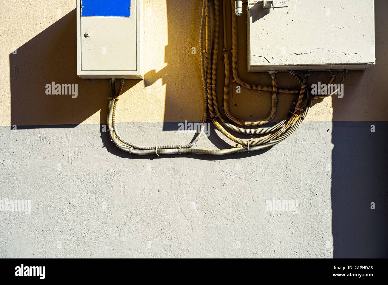 Electrical switchboard on the wall. Hard shadows. Wiring to the ...