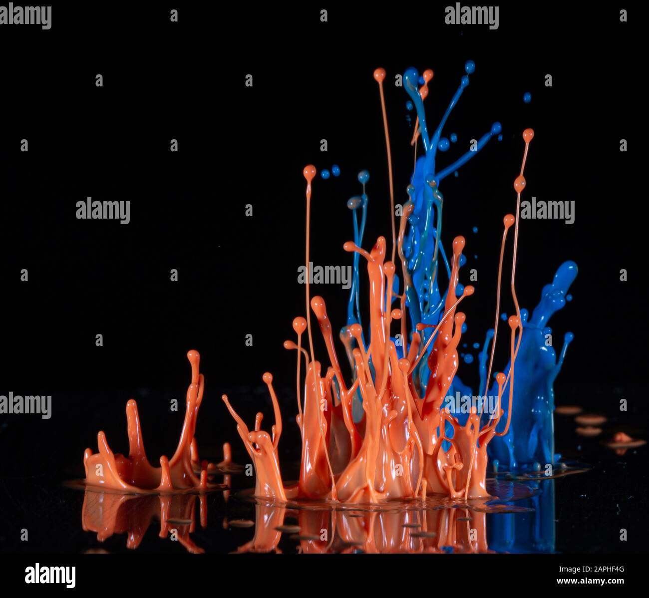 orange ink splash on a black background Stock Photo - Alamy