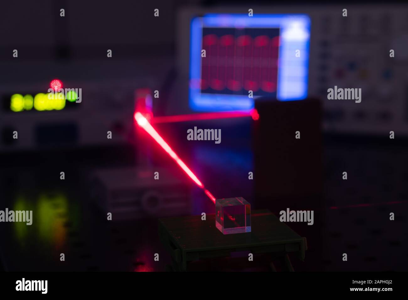 Experiment in optic lab with laser device. Red laser on optical table ...