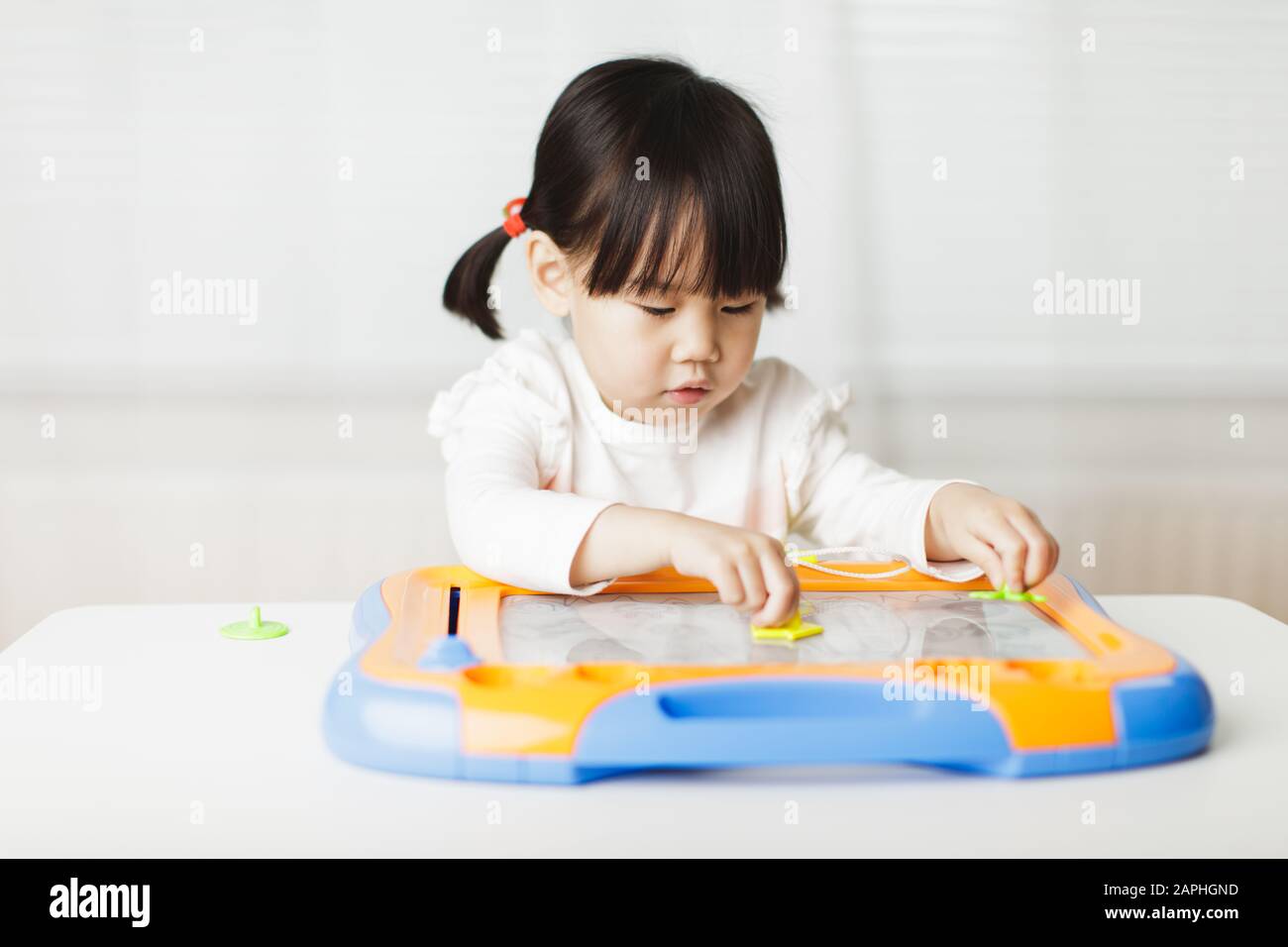 toddler girl learn drawing at home against white background Stock Photo ...