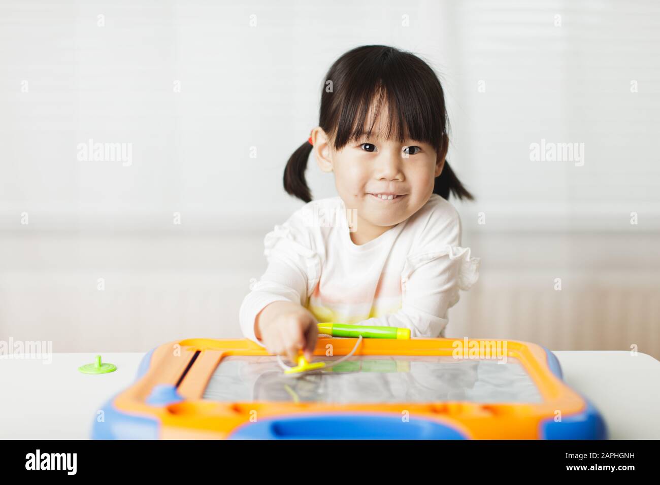 toddler girl learn drawing at home against white background Stock Photo ...