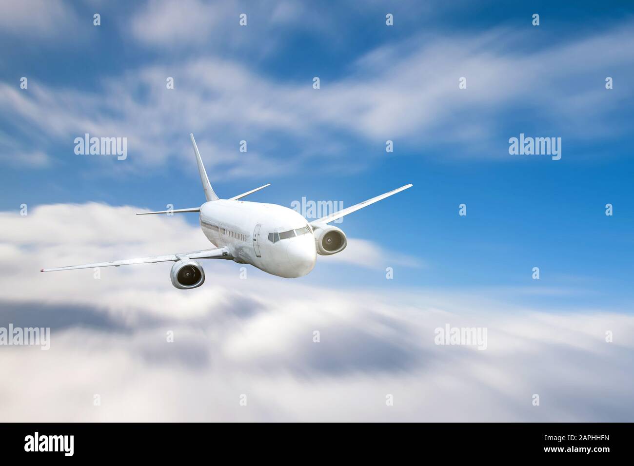 Jet passenger plane flying over cloudy sky in day time Stock Photo - Alamy