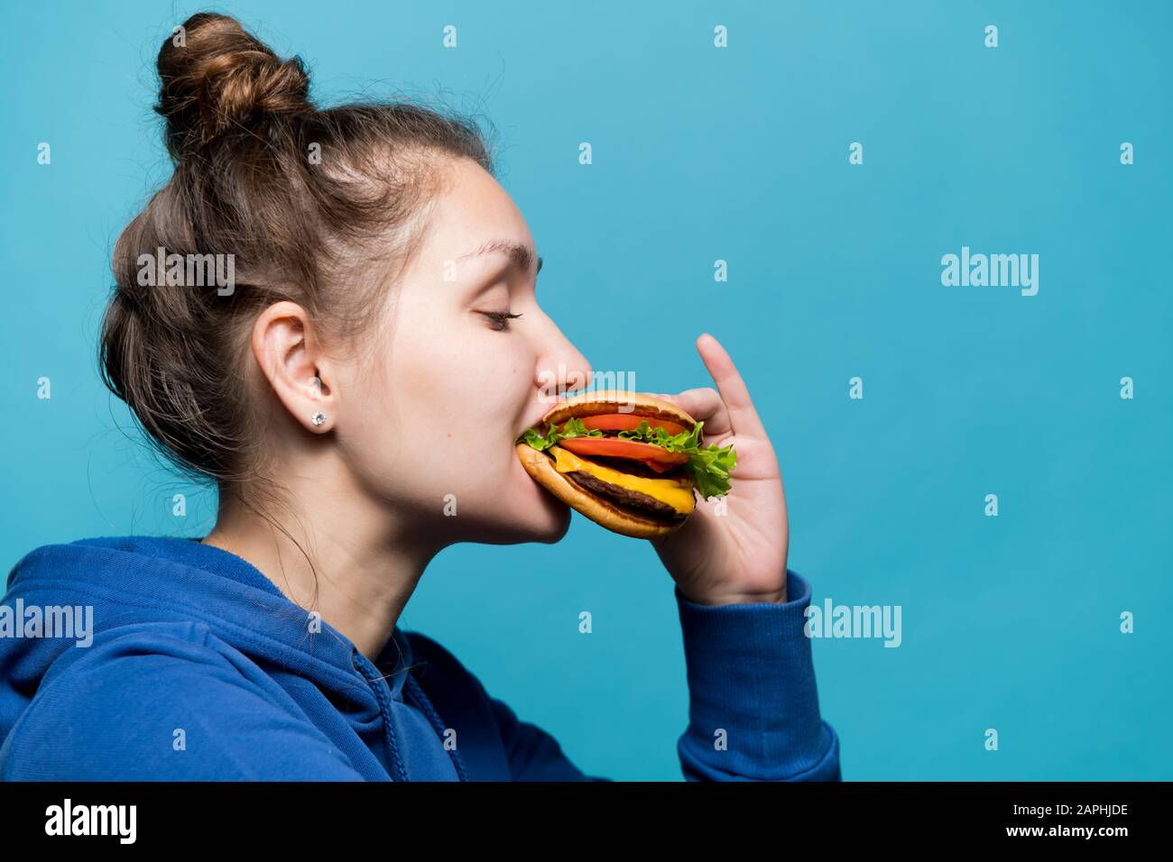 Tired Young Woman Eating Burger High Resolution Stock Photography and ...