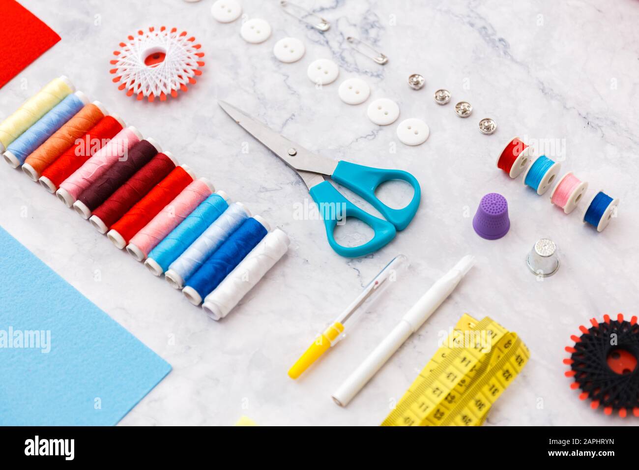 colorful sewing and tailoring tools and items on light background Stock ...