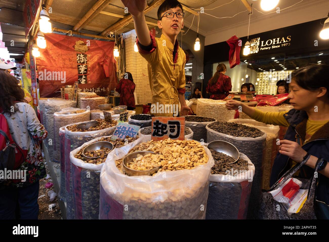 Vendor serves a customer at the Dihua St. Lunar New Year / Chinese New ...