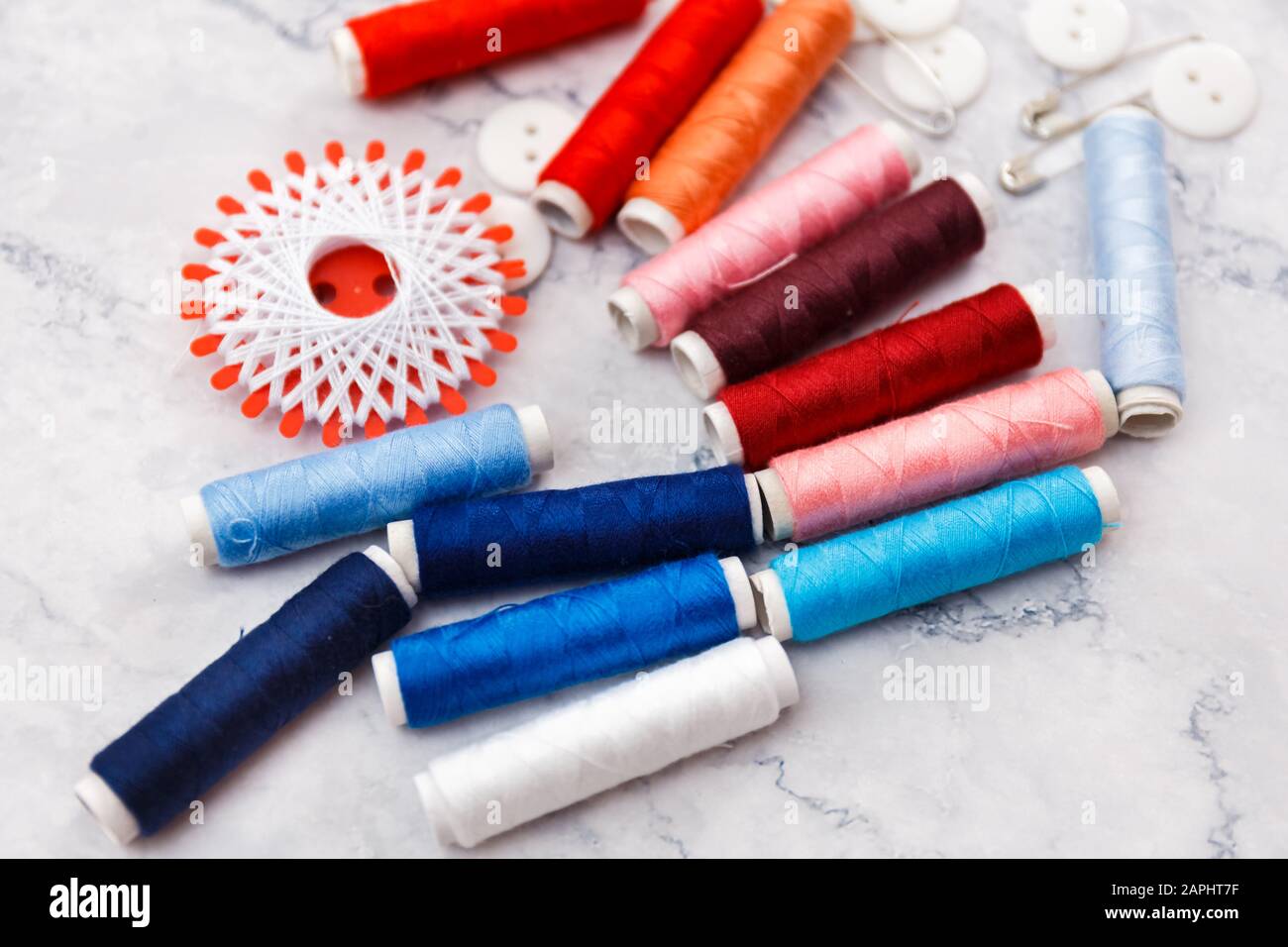 colorful sewing and tailoring tools and items on light background Stock ...