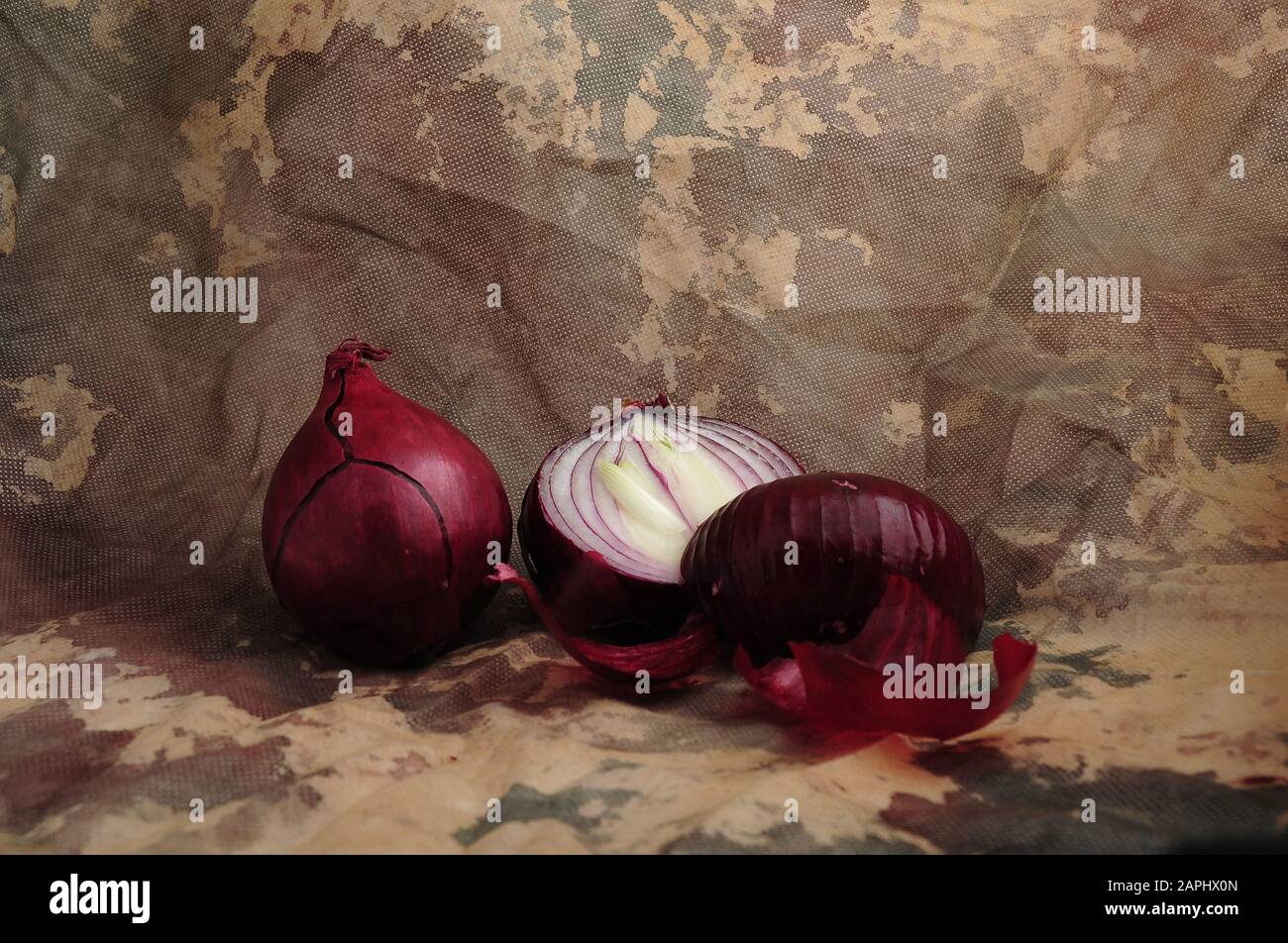 Two red onions. One whole onion and one cut in half. Horizontal photo ...