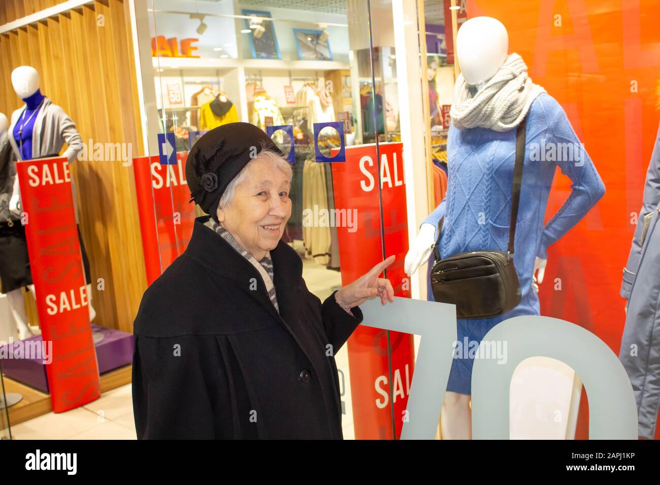 Senior old woman looking at clothes at shopping mall Stock Photo - Alamy