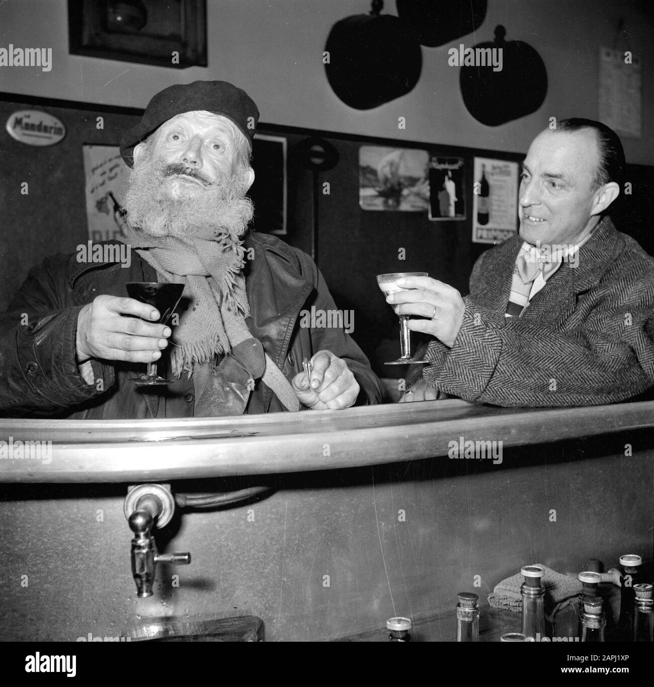 Two men visit a café Description: The two men stand at the bar Date ...