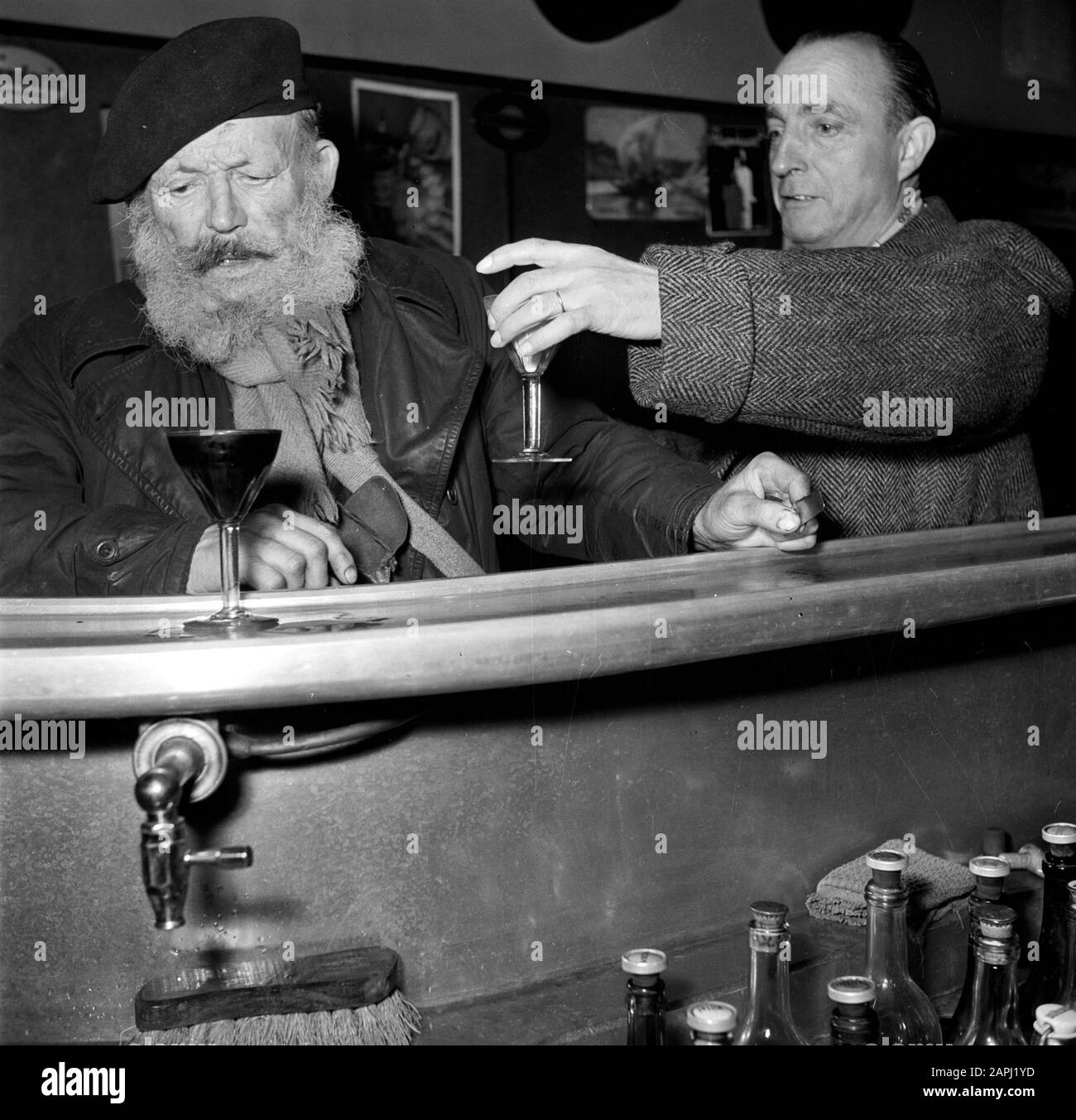 Two men visit a café Description: The two men stand at the bar Date ...