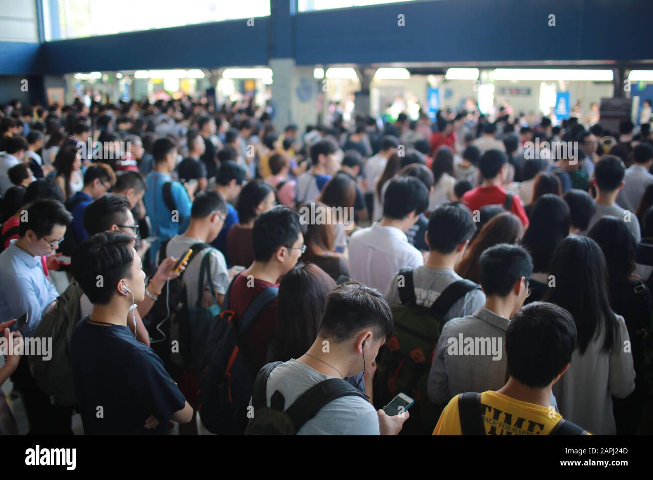 crowd of passengers are waiting in Kowloon Tong station. The crowd ...