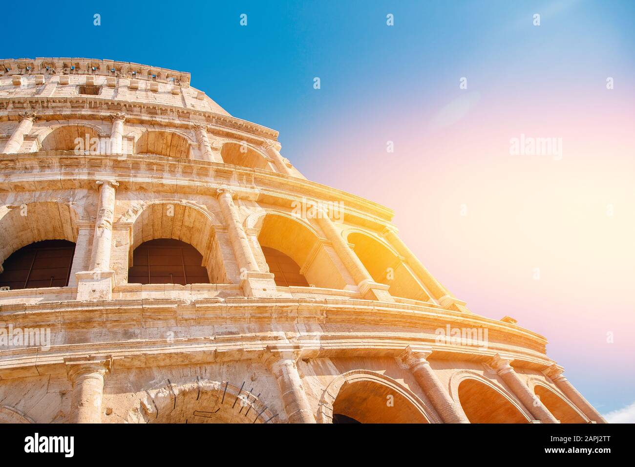 Colosseum or Coliseum ancient ruins background blue sky Rome, Italy ...