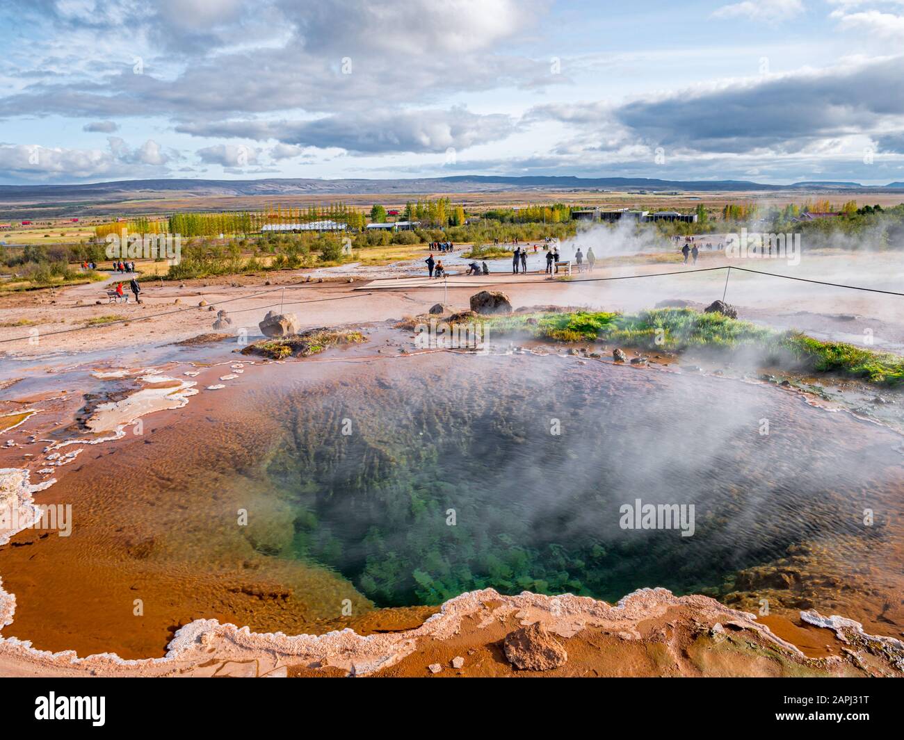 Blue pool with vapour in Haukadalur geothermal area with Strokkur big ...