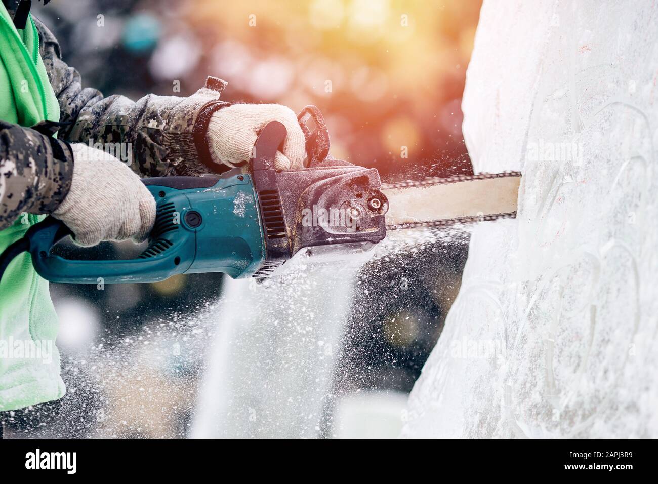 Ice sculpture carving man use chainsaw cut frozen winter Stock Photo ...