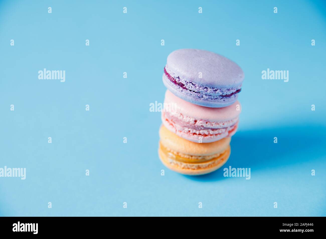 Colorful Cake macaron or macaroon on blue background, pastel color ...