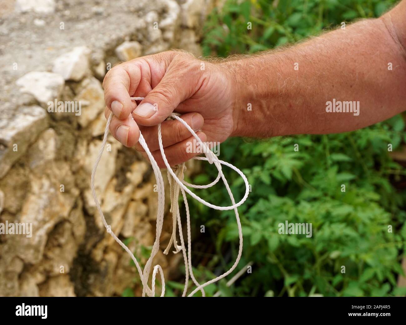 Man hands tied rope hi-res stock photography and images - Alamy