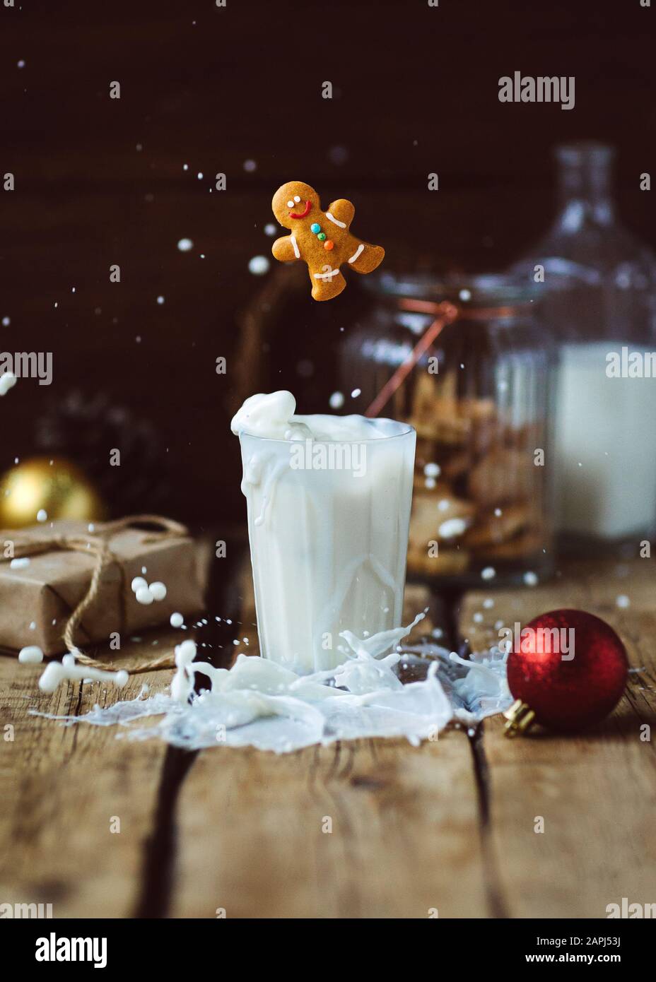 Christmas cookies falling into a glass with milk, splash of milk Stock ...