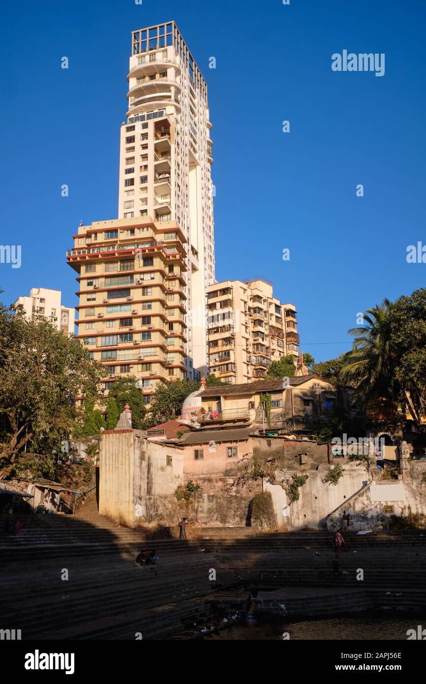 High rise apartment buildings are towering over a Hindu temple at holy ...