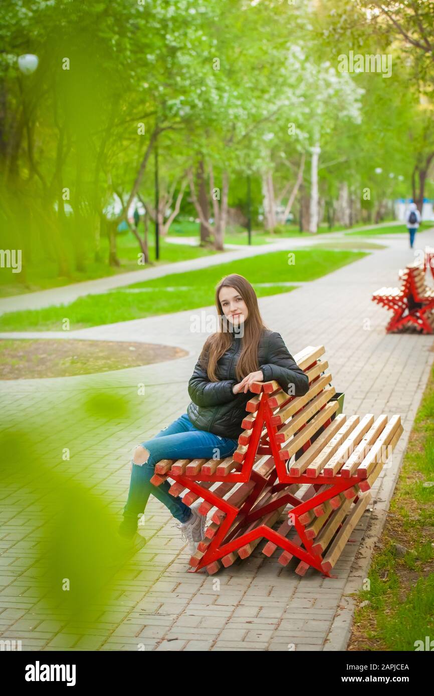 Beautiful girl on a park bench. relaxation. Star Stock Photo - Alamy