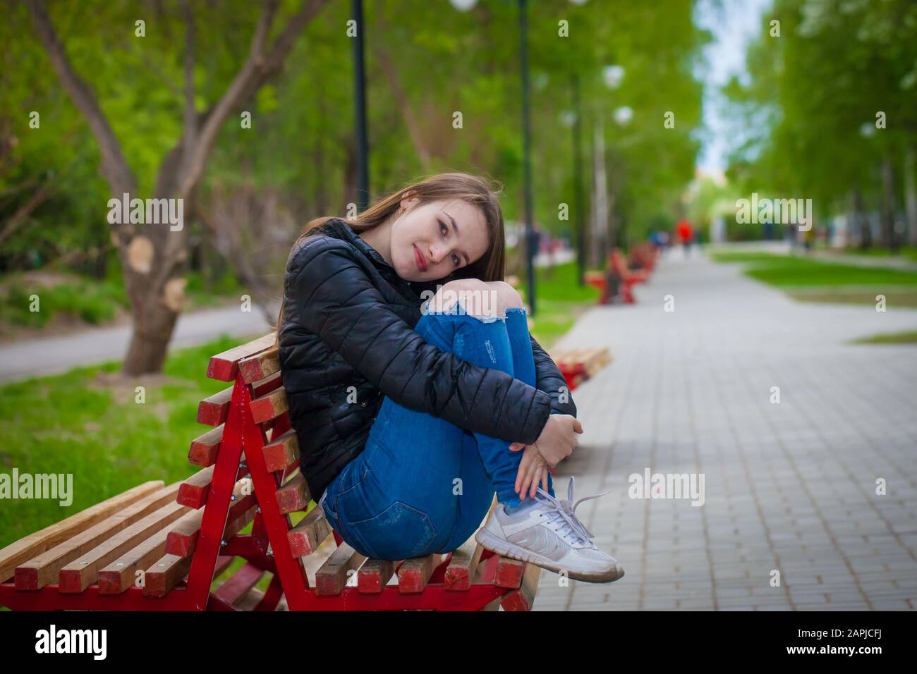 Beautiful girl on a park bench. relaxation. Star Stock Photo - Alamy
