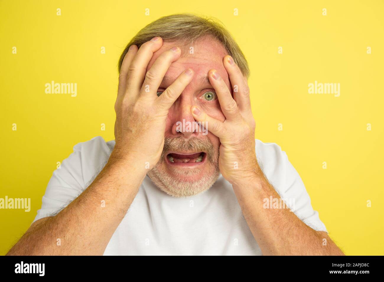 Shocked, scared, covering face with hands. Caucasian man portrait ...