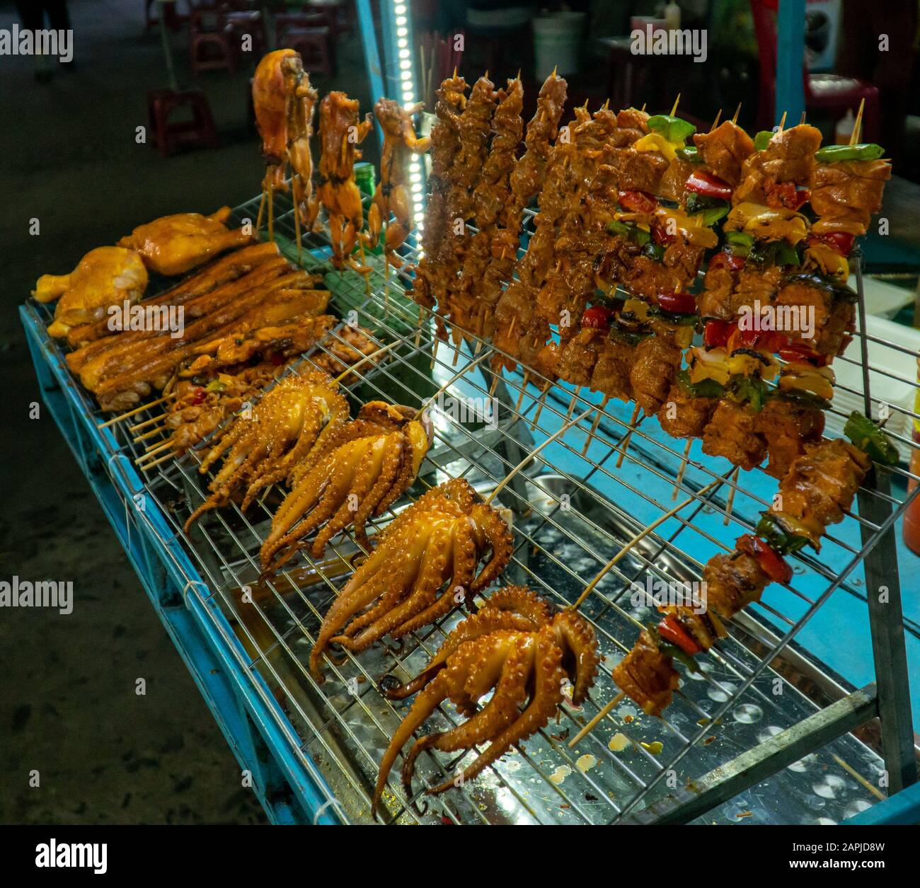 Grilled octopus and meat skewers street vendor Hoi An Vietnam at night ...