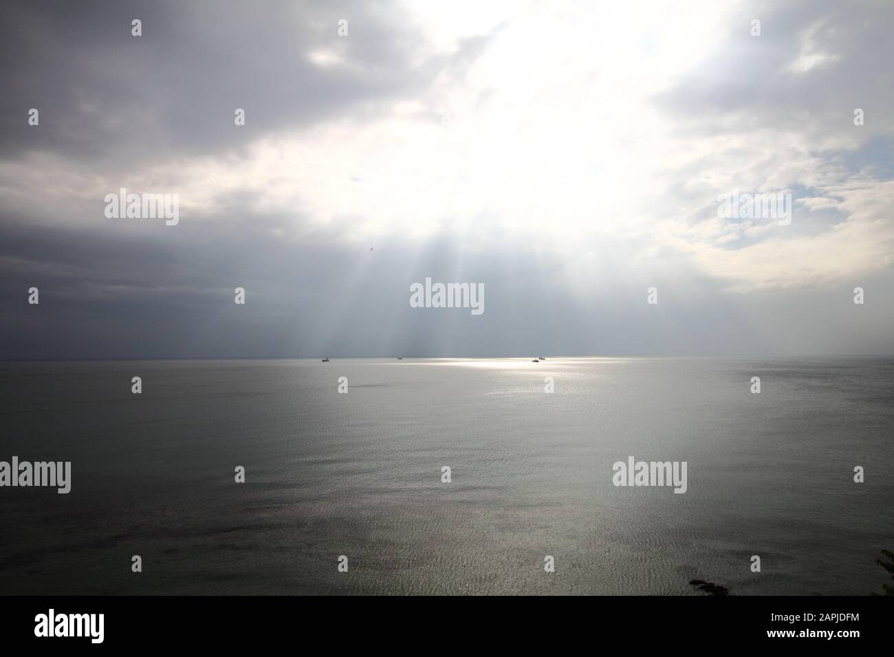 Sun rays beaming through picturesque clouds above the sea. Sun, clouds ...