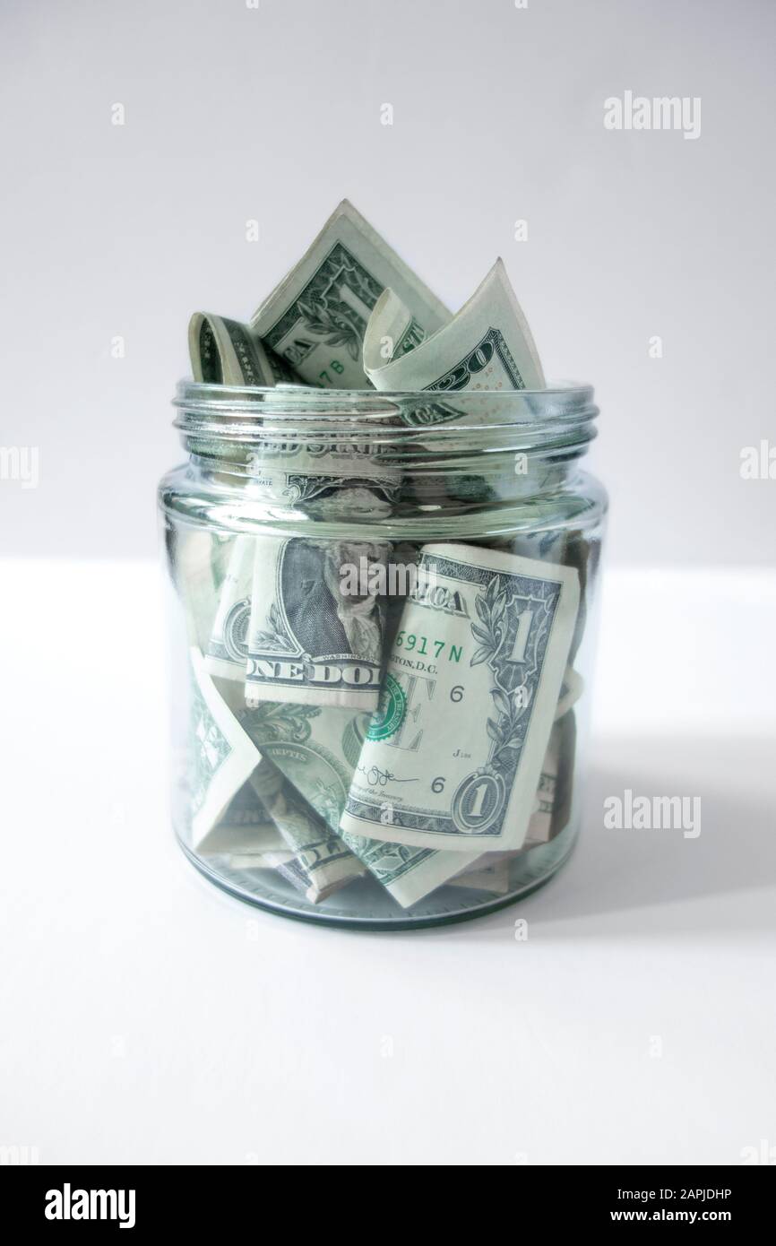 One hundred dollar bills jar hi-res stock photography and images - Alamy