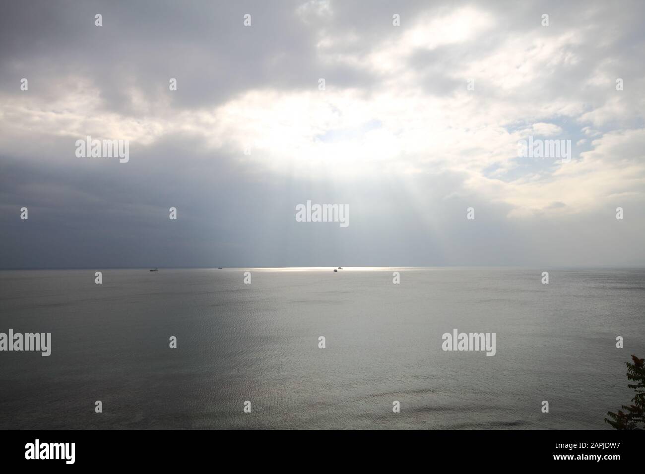 Sun rays beaming through picturesque clouds above the sea. Sun, clouds ...