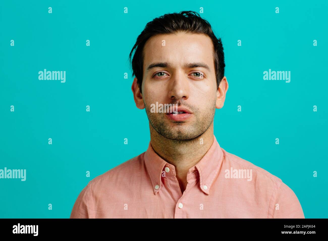 Portrait of a young adult man serious, looking forward, isolated on ...