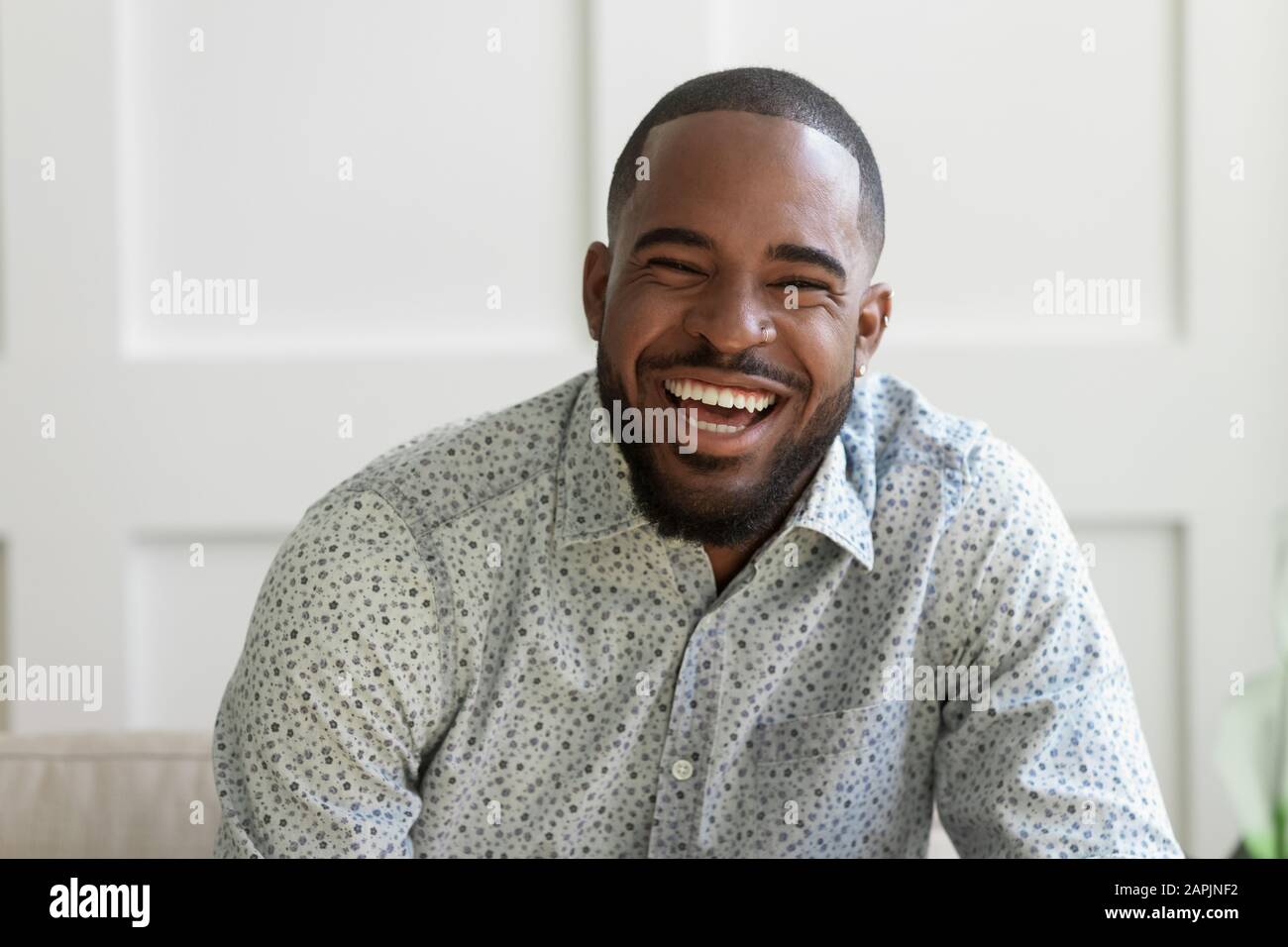 African bearded man looking at camera laughing feels overjoyed Stock ...
