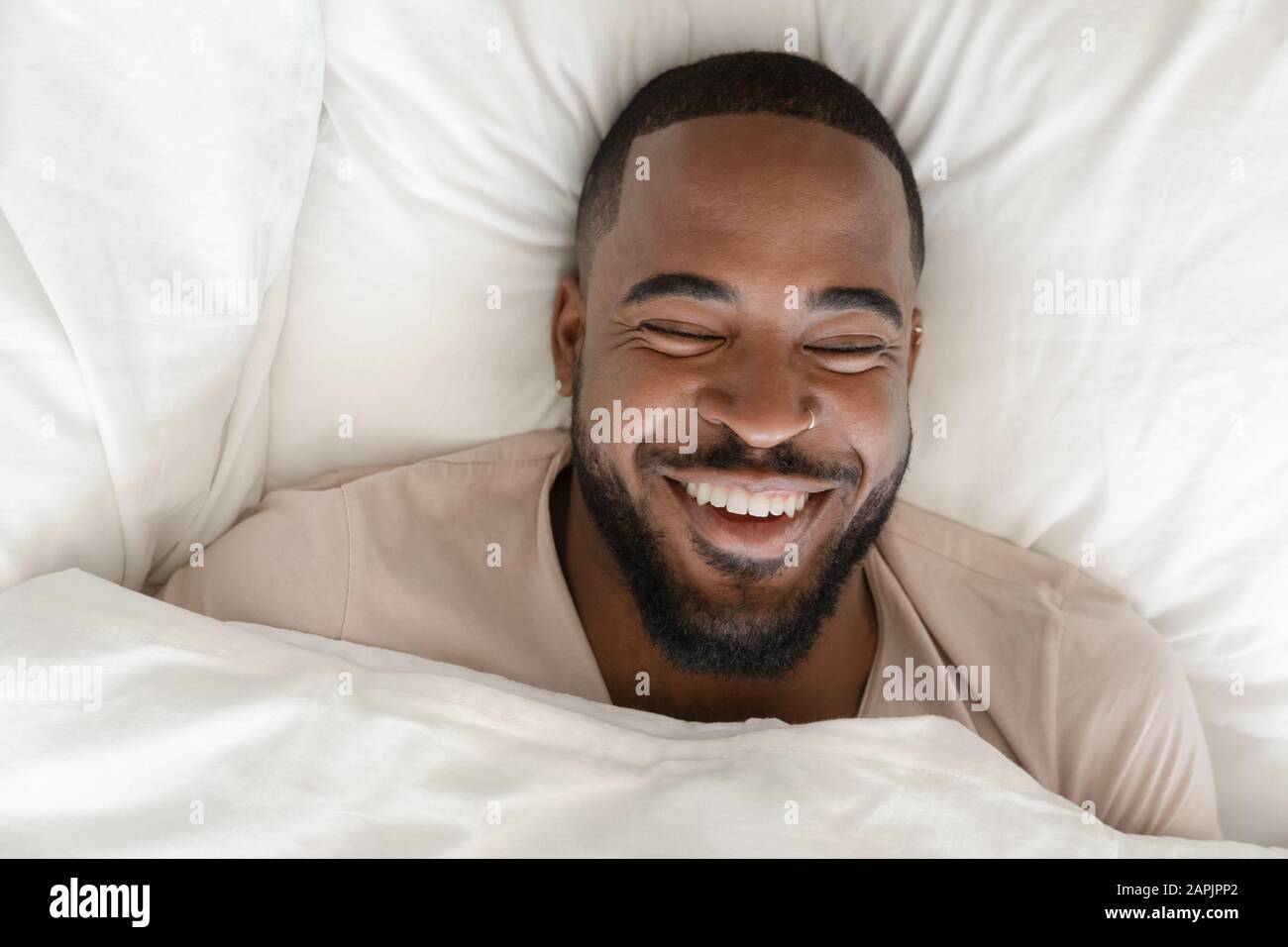 Man lying in bed alone lazy hi-res stock photography and images - Alamy