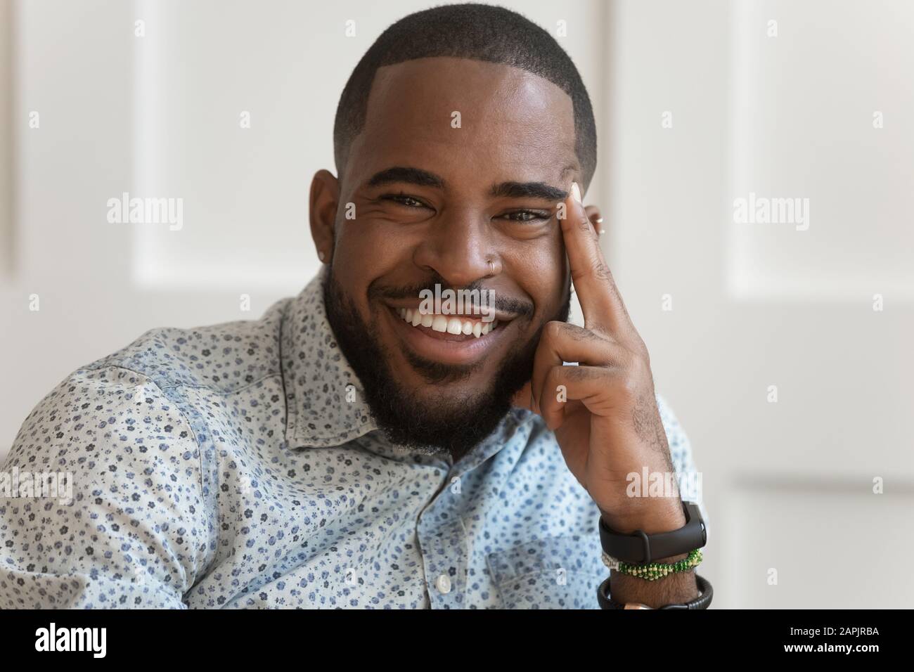 Closeup portrait african guy smiling looking at camera Stock Photo - Alamy