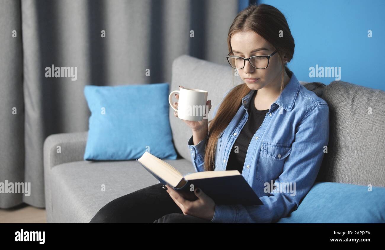 Girl reading book having coffee Stock Photo - Alamy