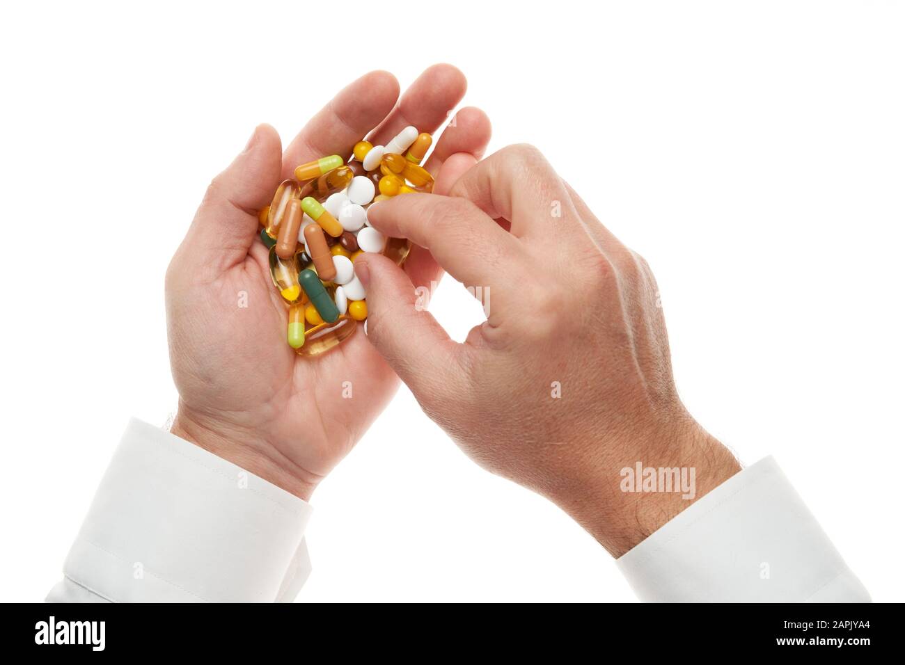 Man hand getting one pill from handful of pills, tablets, vitamins ...
