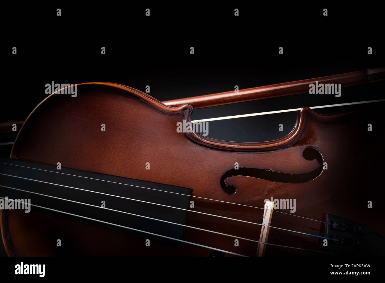 Violin detail with bow and isolated black background. Front view ...