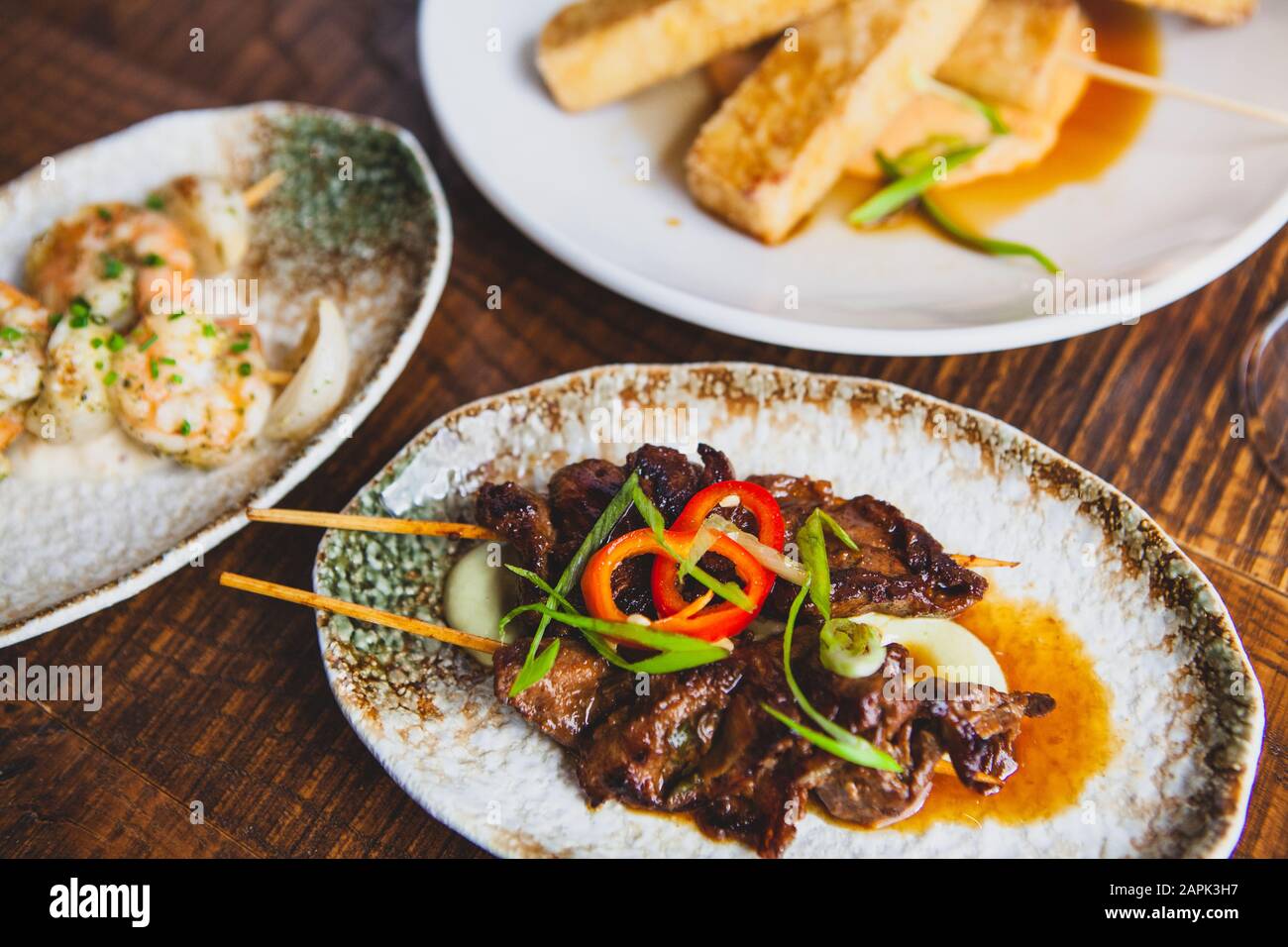 Table setting of different skewered appetizers Stock Photo - Alamy