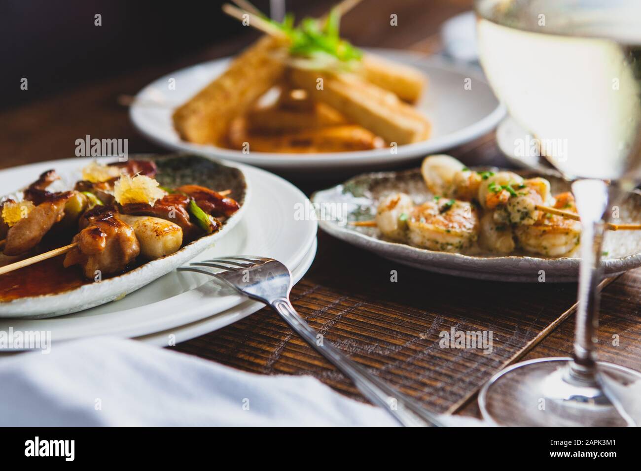 Table setting of different skewered appetizers Stock Photo - Alamy