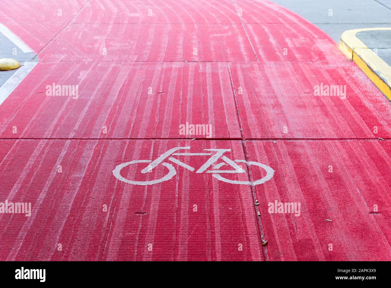 A new red bike path in Berlin with white bike symbol Stock Photo - Alamy