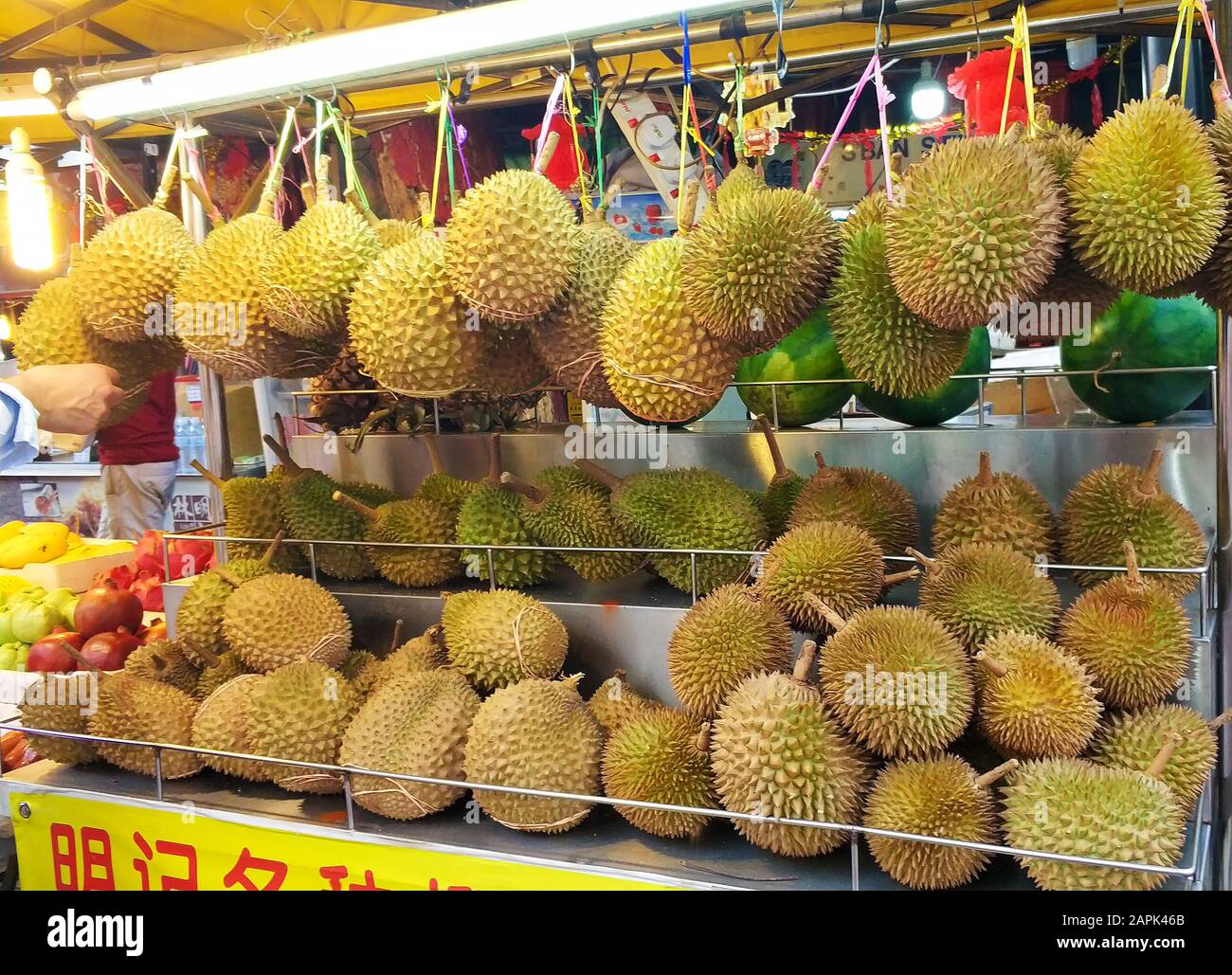 Fresh stinky durian fruit in a window display of a street Asian store ...