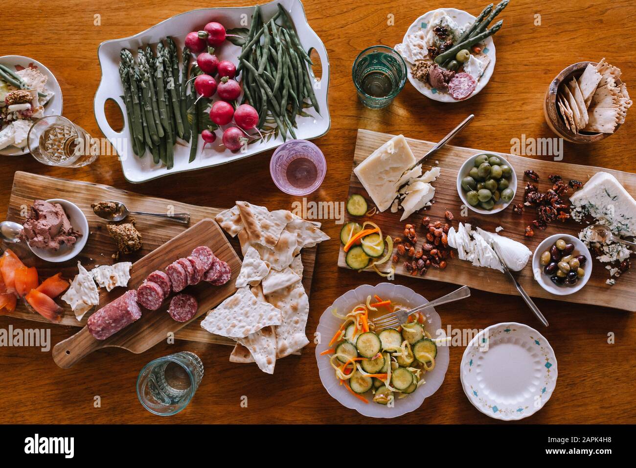 Spread of appetizers on wooden cutting boards and table Stock Photo - Alamy