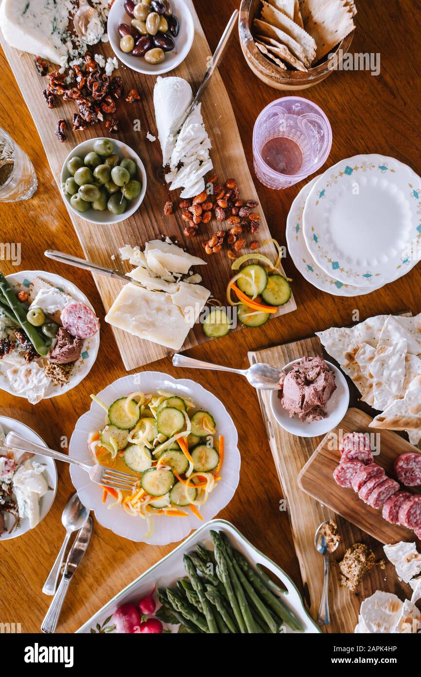Spread of appetizers on wooden cutting boards and table Stock Photo - Alamy