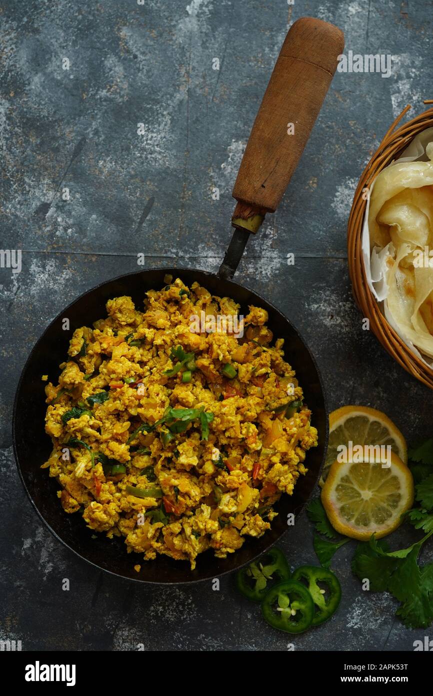 Scrambled eggs/ Masala egg Bhurji served with roti, selective focus ...