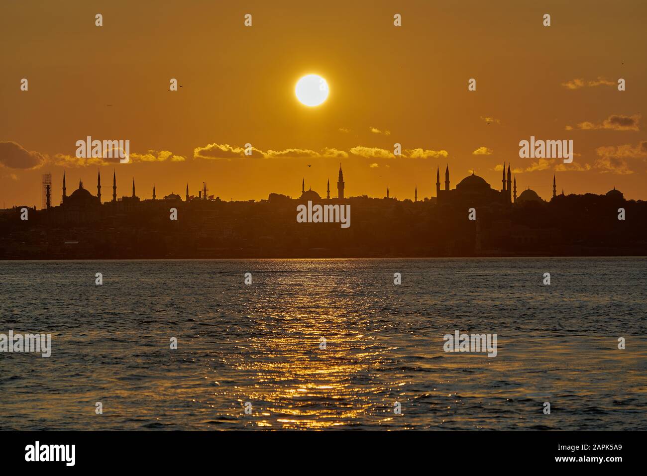 Beautiful sunset in Istanbul, Turkey. Sun is above silhouettes of Hagia ...