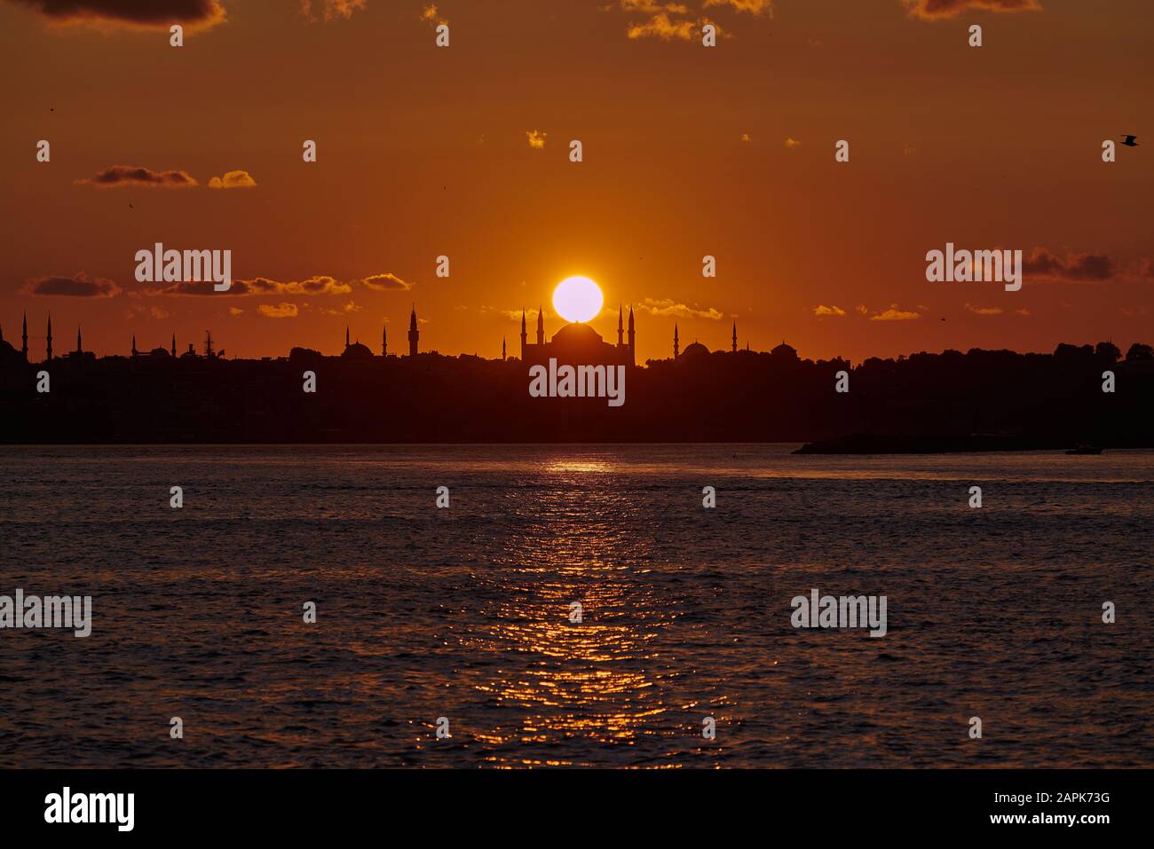 Beautiful sunset in Istanbul, Turkey. Sun is above silhouettes of Hagia ...