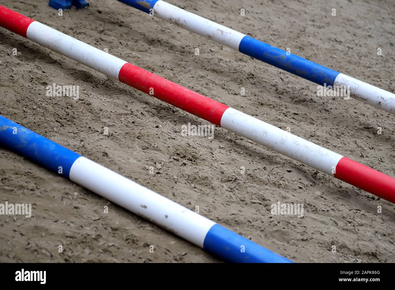 Colorful obstacles waiting for horse riders at rural equestrian centre ...