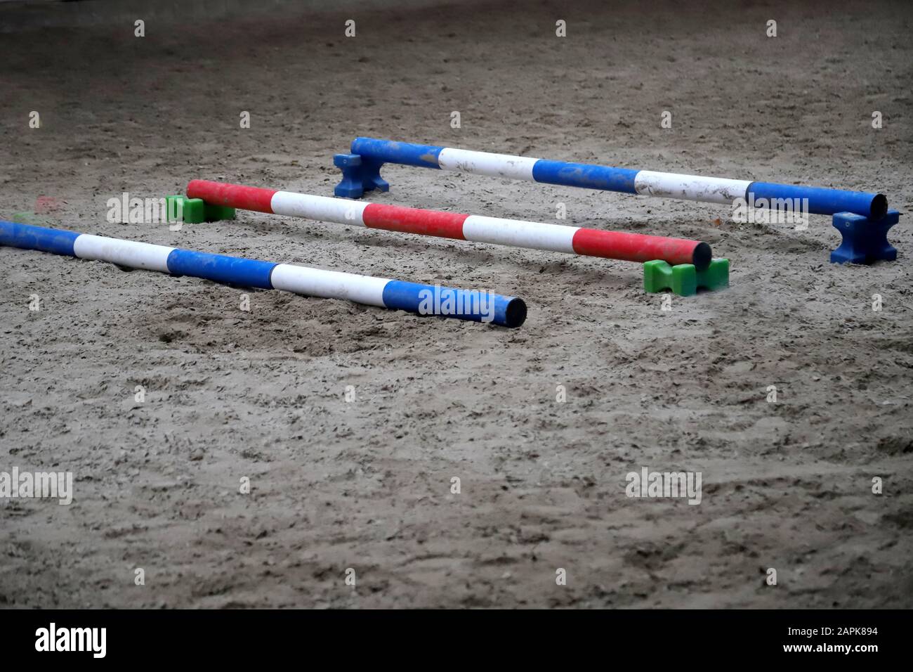 Colorful obstacles waiting for horse riders at rural equestrian centre ...