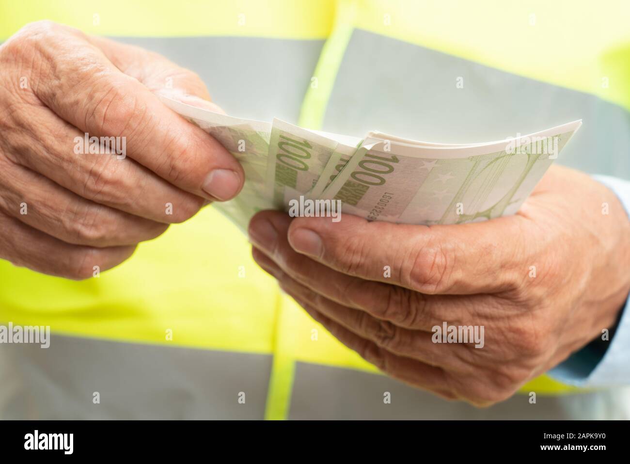 Closeup of male architect counting money as bribe or payment concept ...