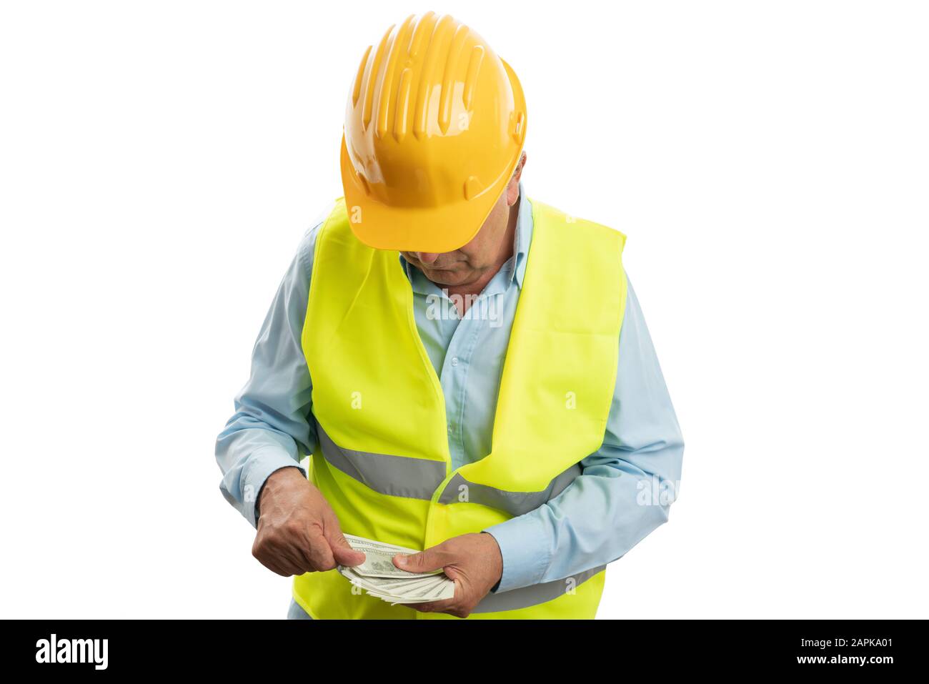 Serious old male engineer counting dollars as salary or bribe money ...