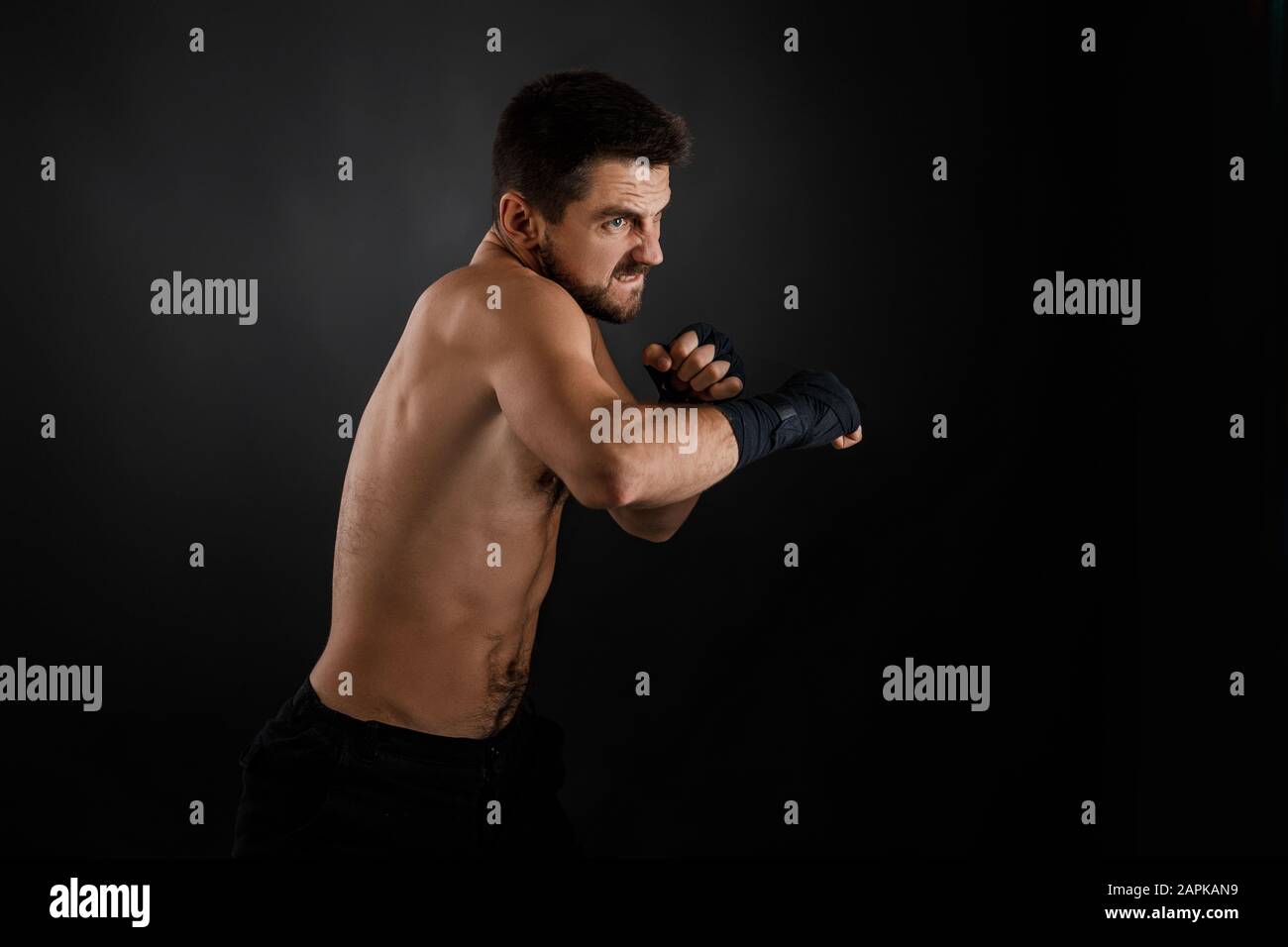 Sportsman boxer throwing a fierce and powerful punch. muscular man on ...